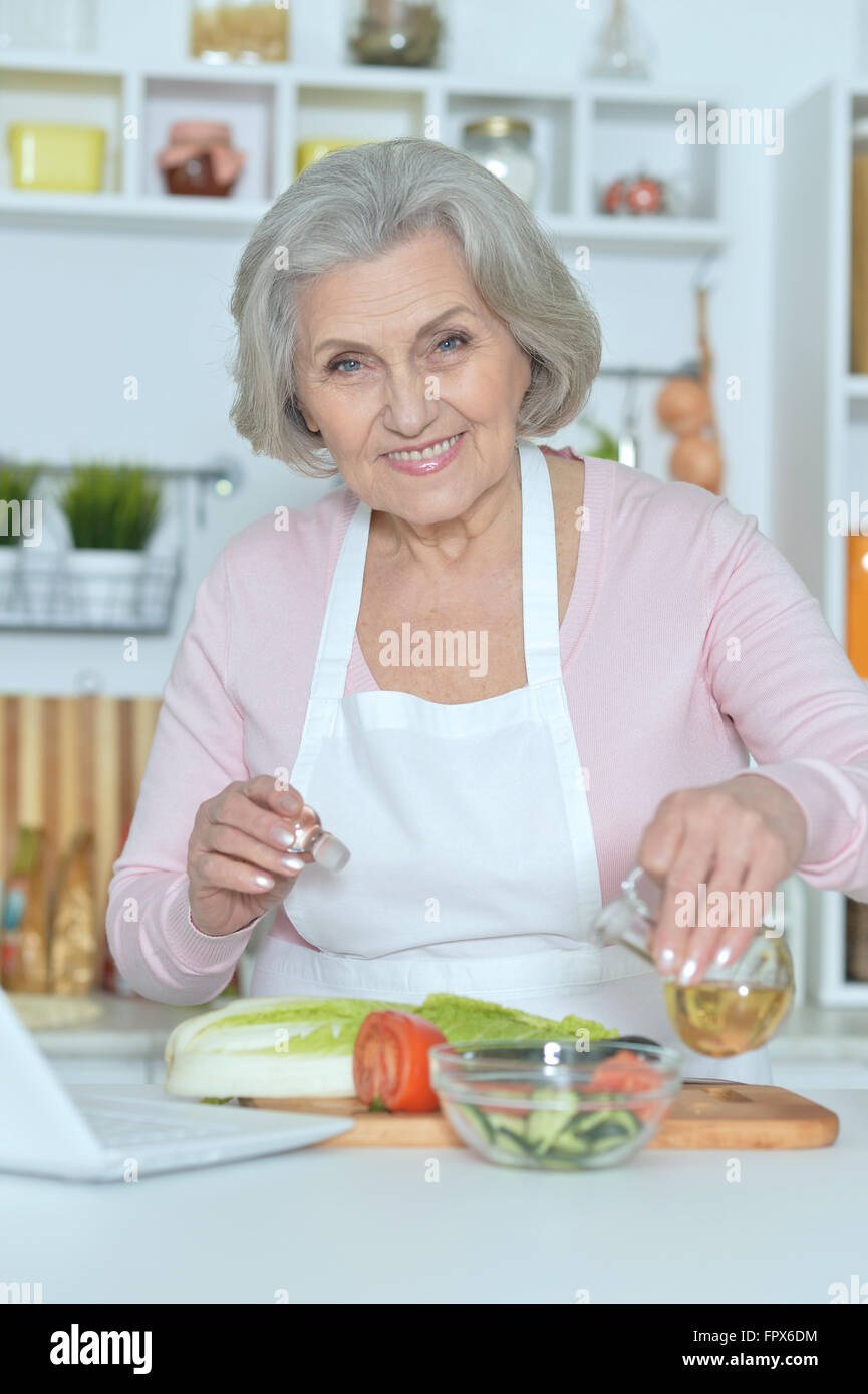 Senior woman cooking in kitchen Stock Photo - Alamy