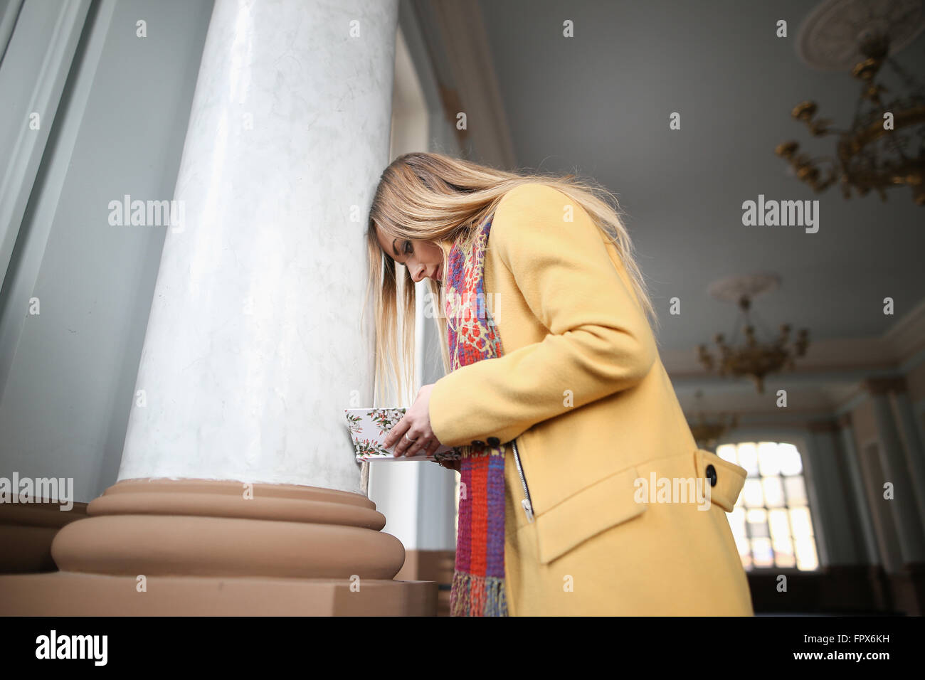 Beautiful blonde smiles optimism cold spring. in anticipation of ...