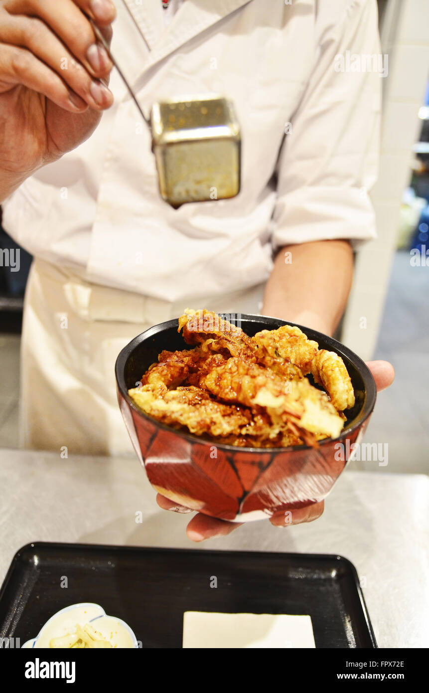 Chef pouring soy sauce on Tempura rice bowl Stock Photo - Alamy