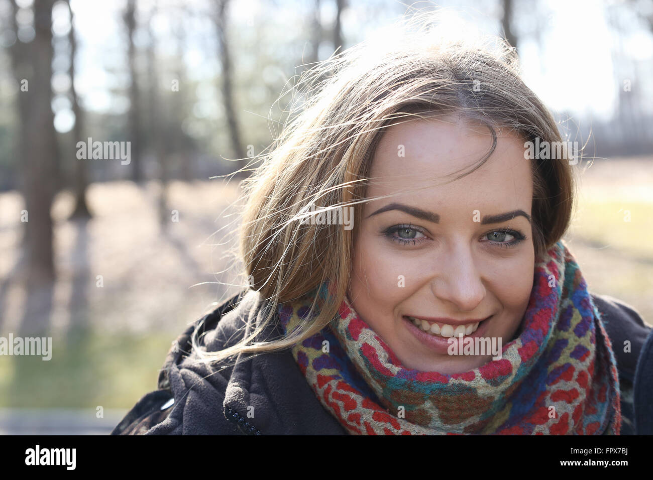 Close Up Of Young Woman's Eyes As She Smiles, Her Hair Blows In The ...