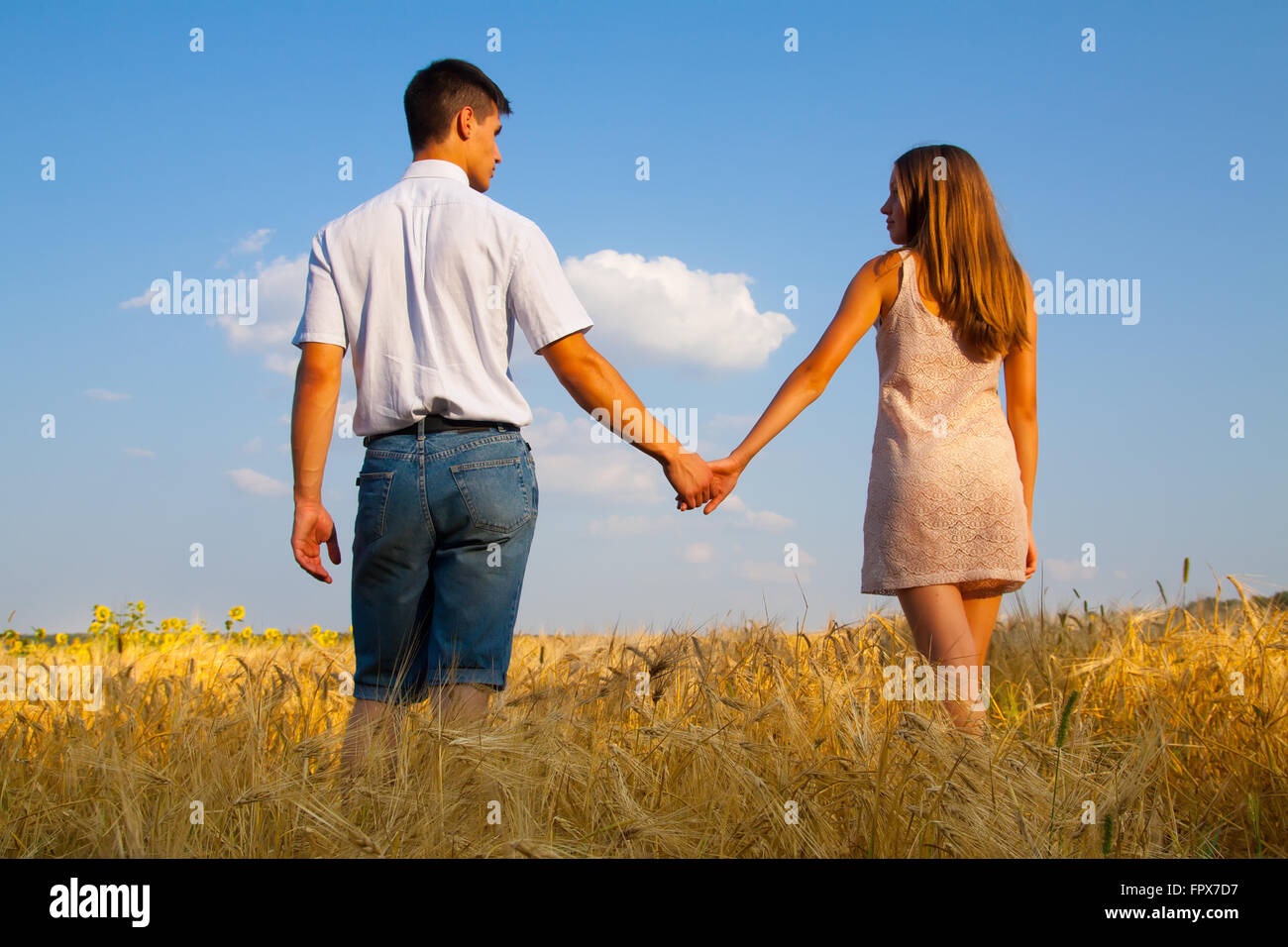 Couple Holding Hands In Field