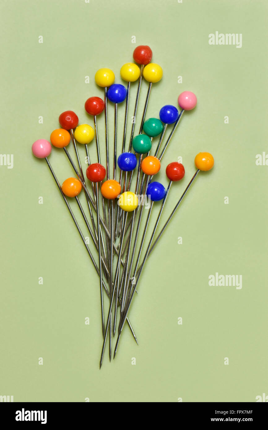 Colourful berry pins on green background in shape of a bunch of flowers ...