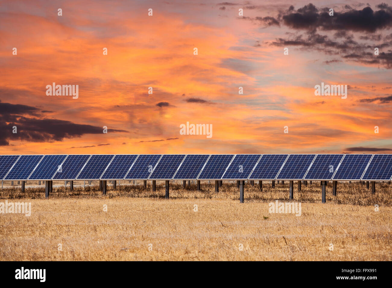 Solar panels with orange sunrise clouds Stock Photo - Alamy
