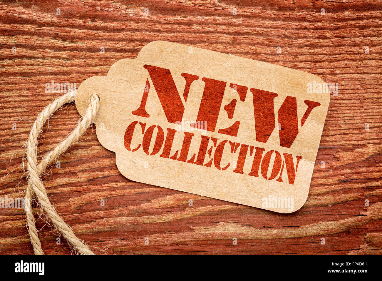 new collection sign - red stencil text on a paper price tag against ...