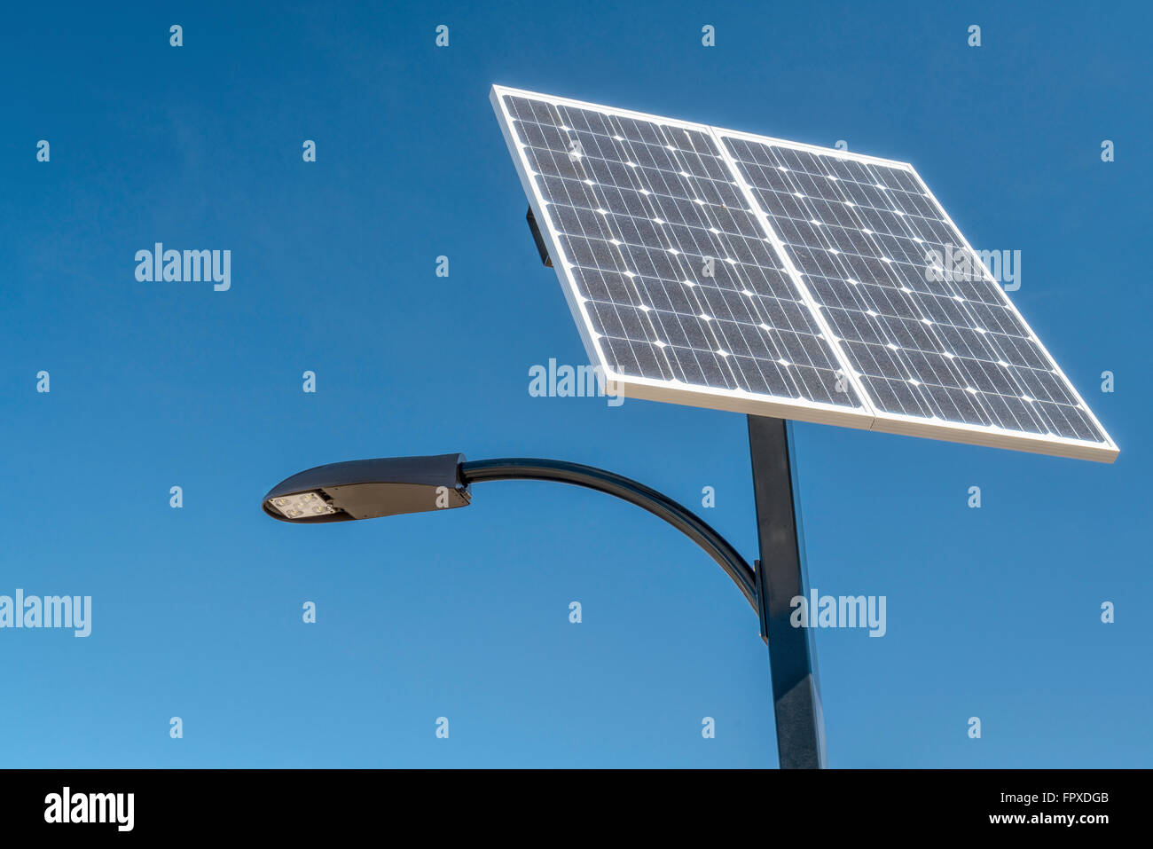 street lamp with a solar panel against blue sky Stock Photo - Alamy