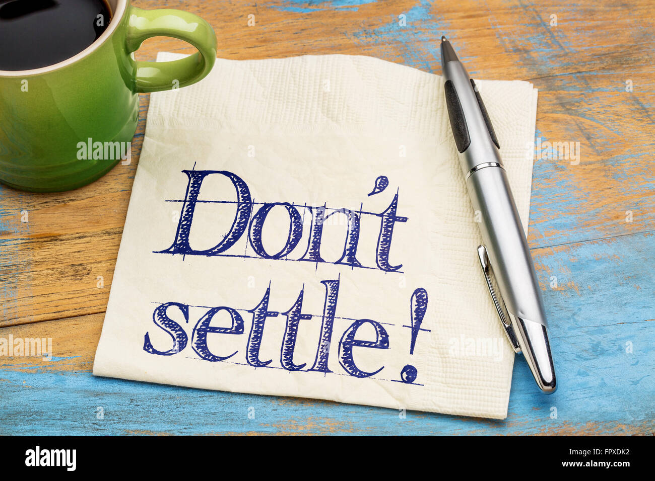 Do not settle reminder - handwriting on a napkin with a cup of coffee ...