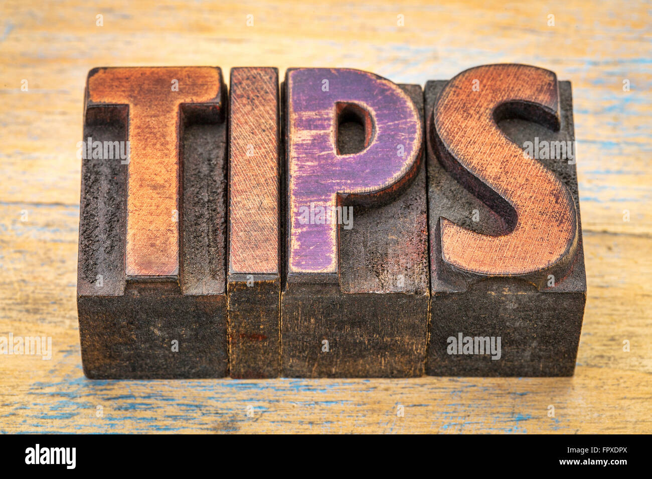 tips word in vintage letterpress wood type printing blocks stained by ...