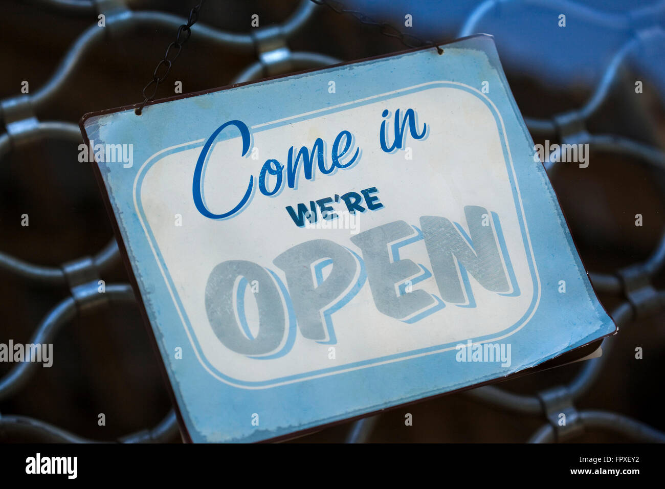 Close up of an open sign on an iron curtain Stock Photo - Alamy