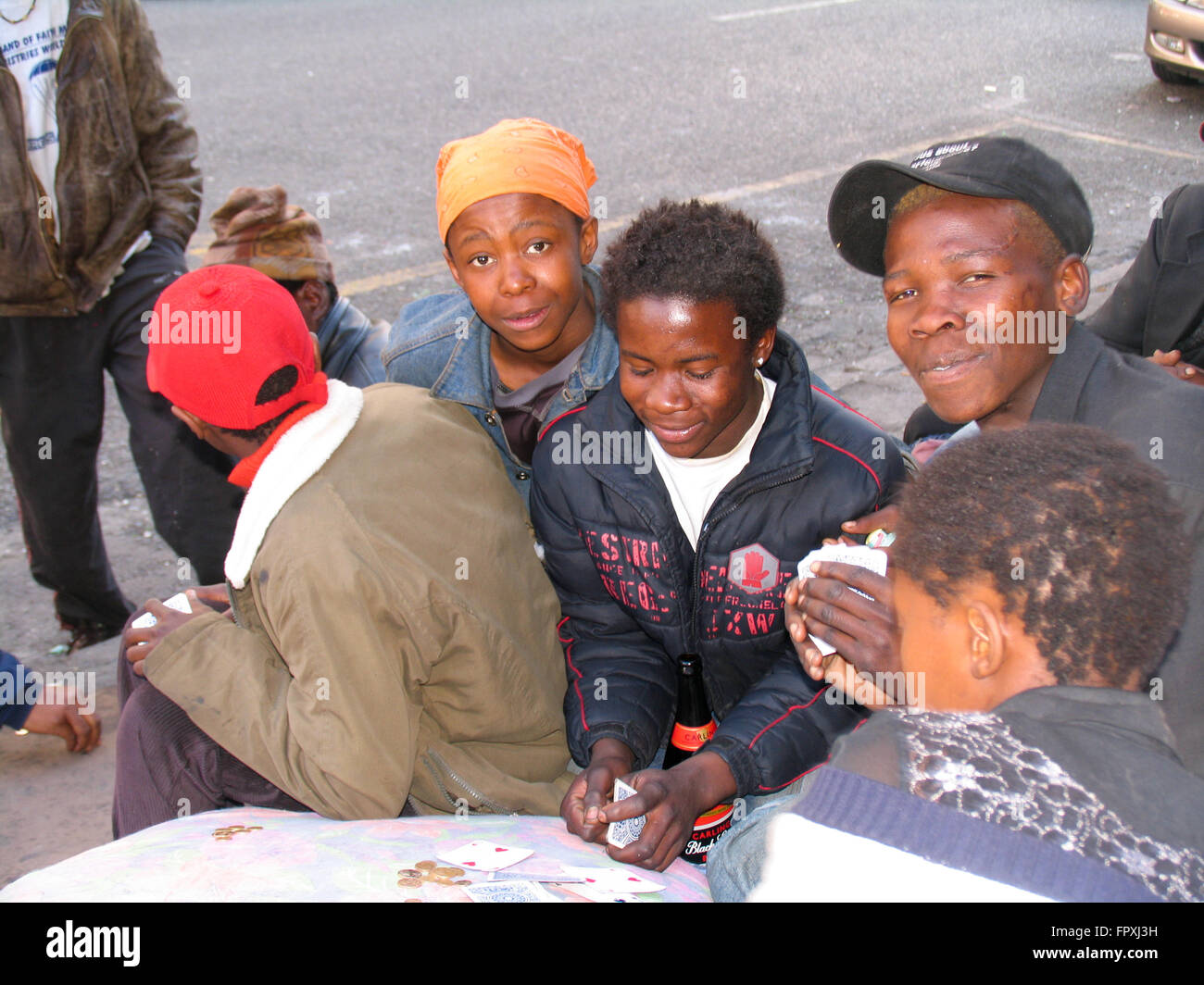 A group of youths on the street playing a card game Stock Photo - Alamy