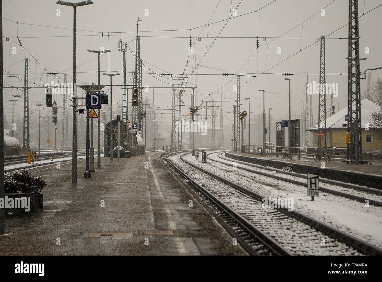 Snowfall over the tracks at a train station in Southern Germany Stock ...
