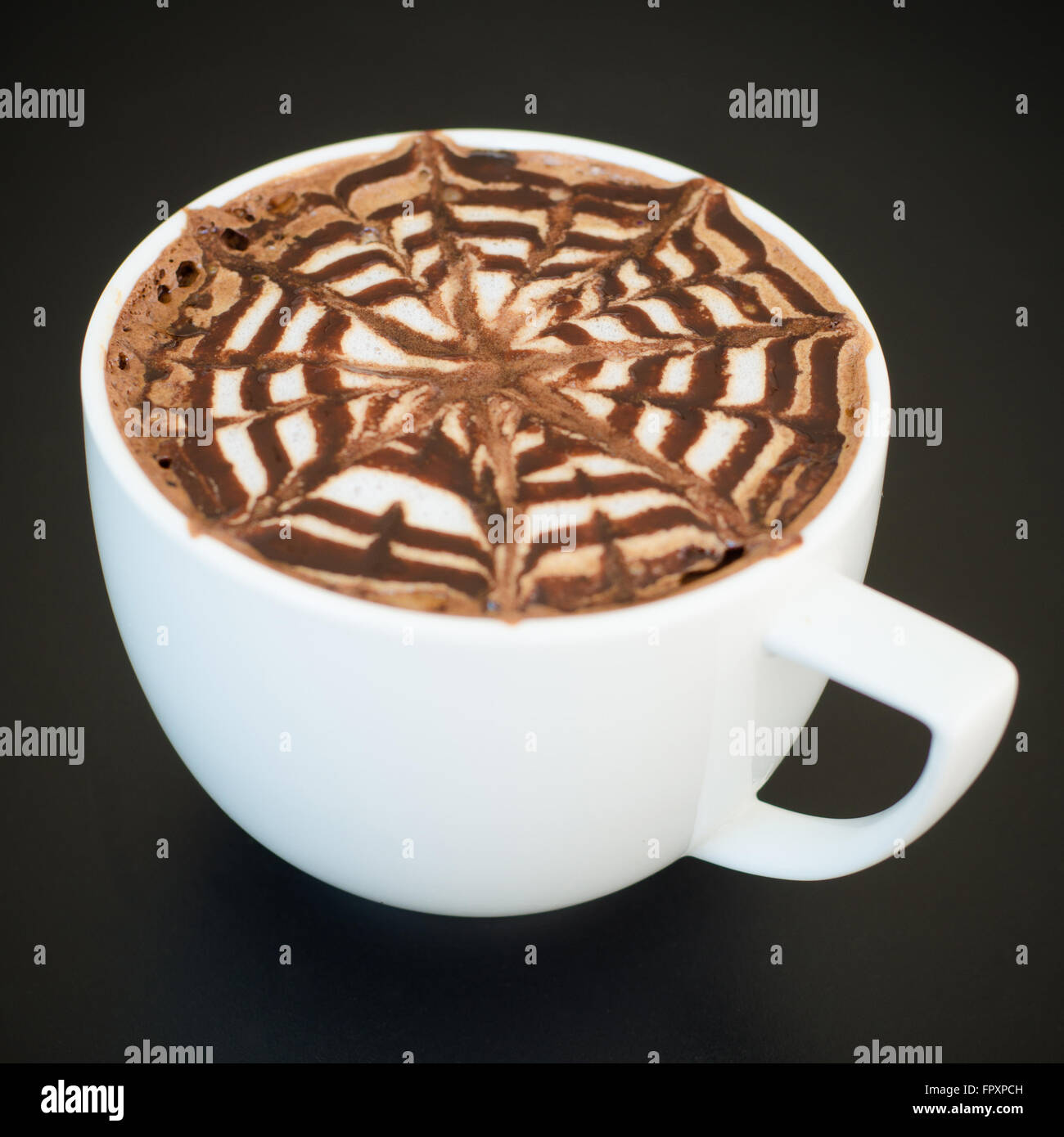 a cup of latte art on black background Stock Photo - Alamy