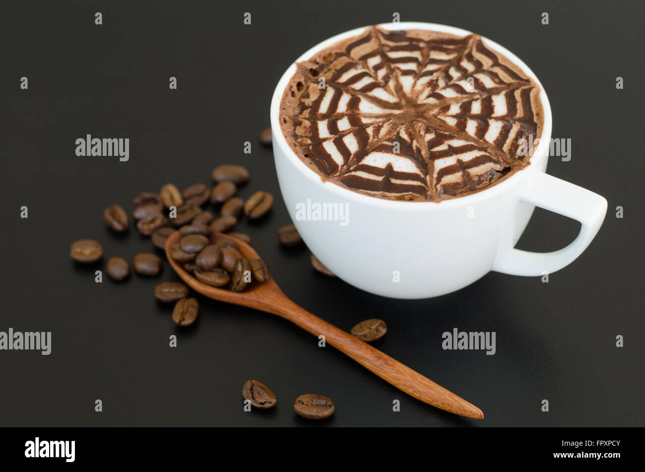 a cup of latte art on black background Stock Photo - Alamy