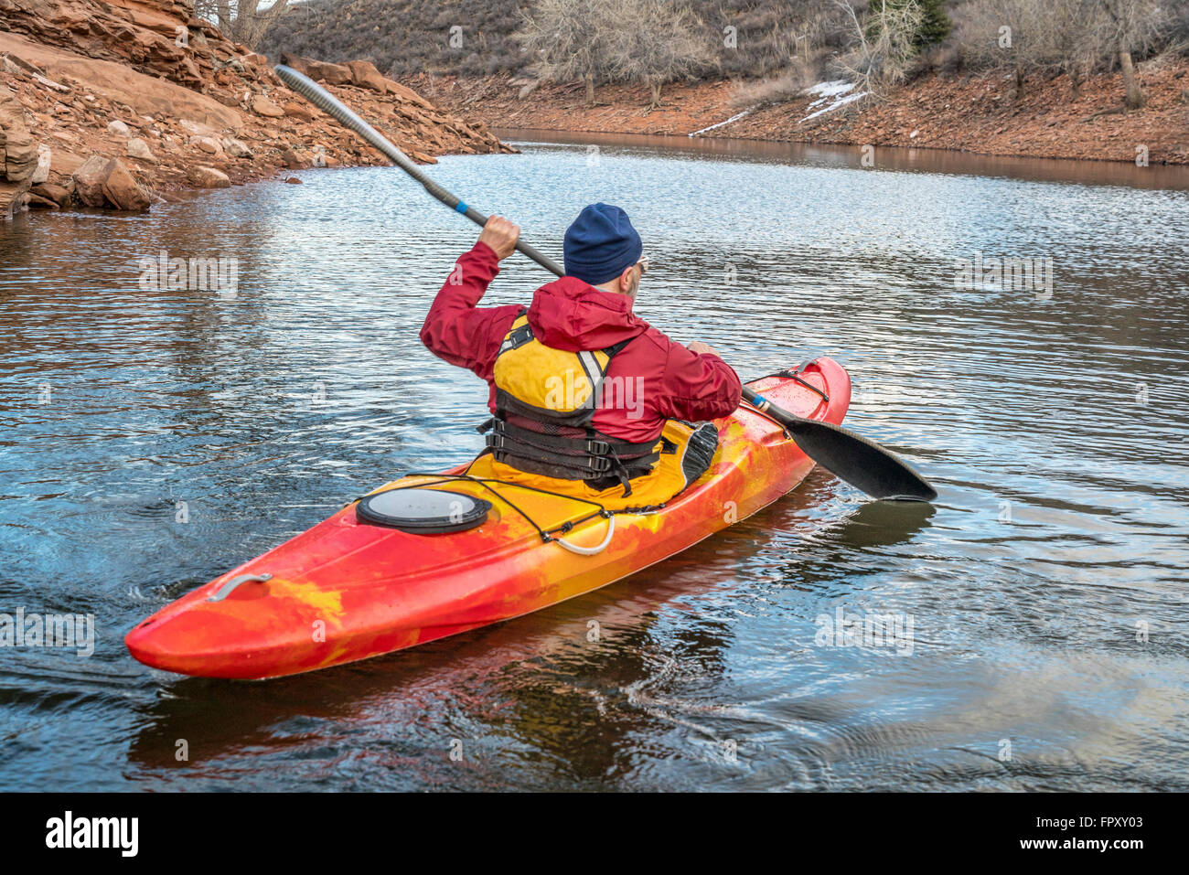 paddling colorful kayak on a calm river or lake - recreation concept ...
