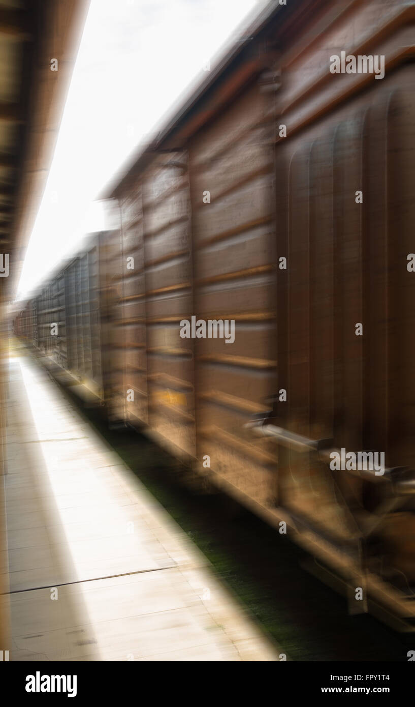 Freight train carriages speeding by Stock Photo - Alamy