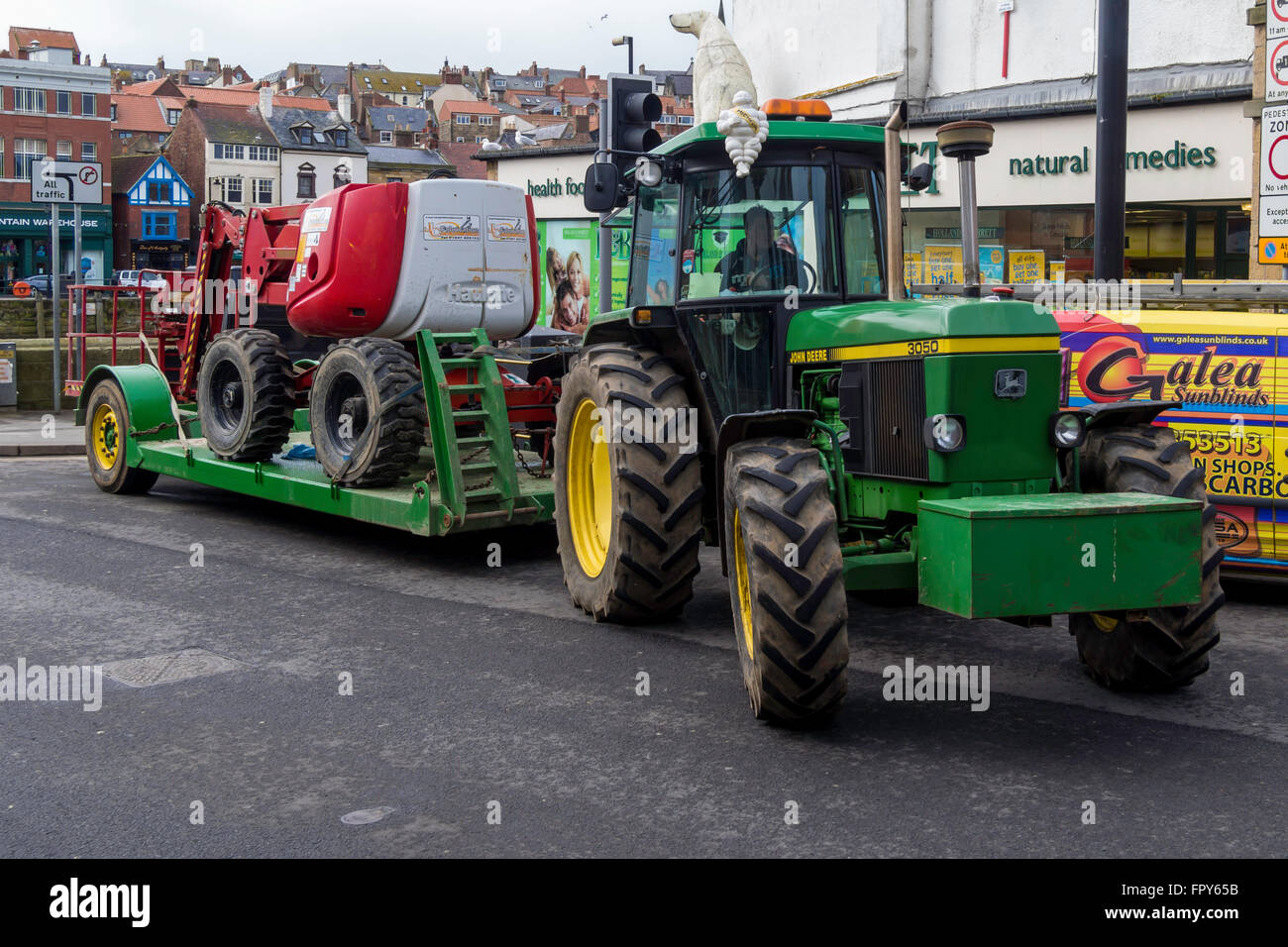 A John Deere 3050 tractor and trailer for delivery of a Haulotte ...