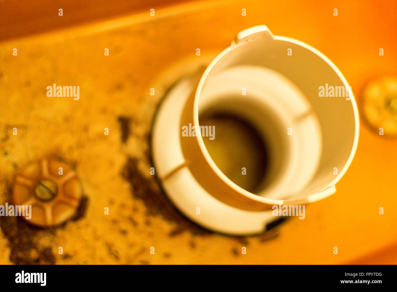 Close-up shot of a toilet tank flush system with missing float and ...