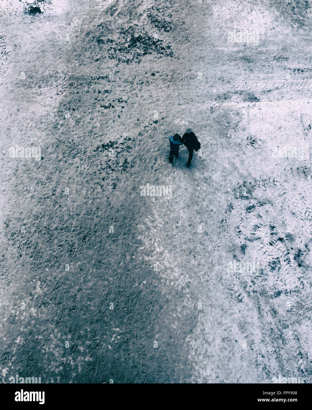 People walk along a snow covered path in winter as seen from an aerial ...