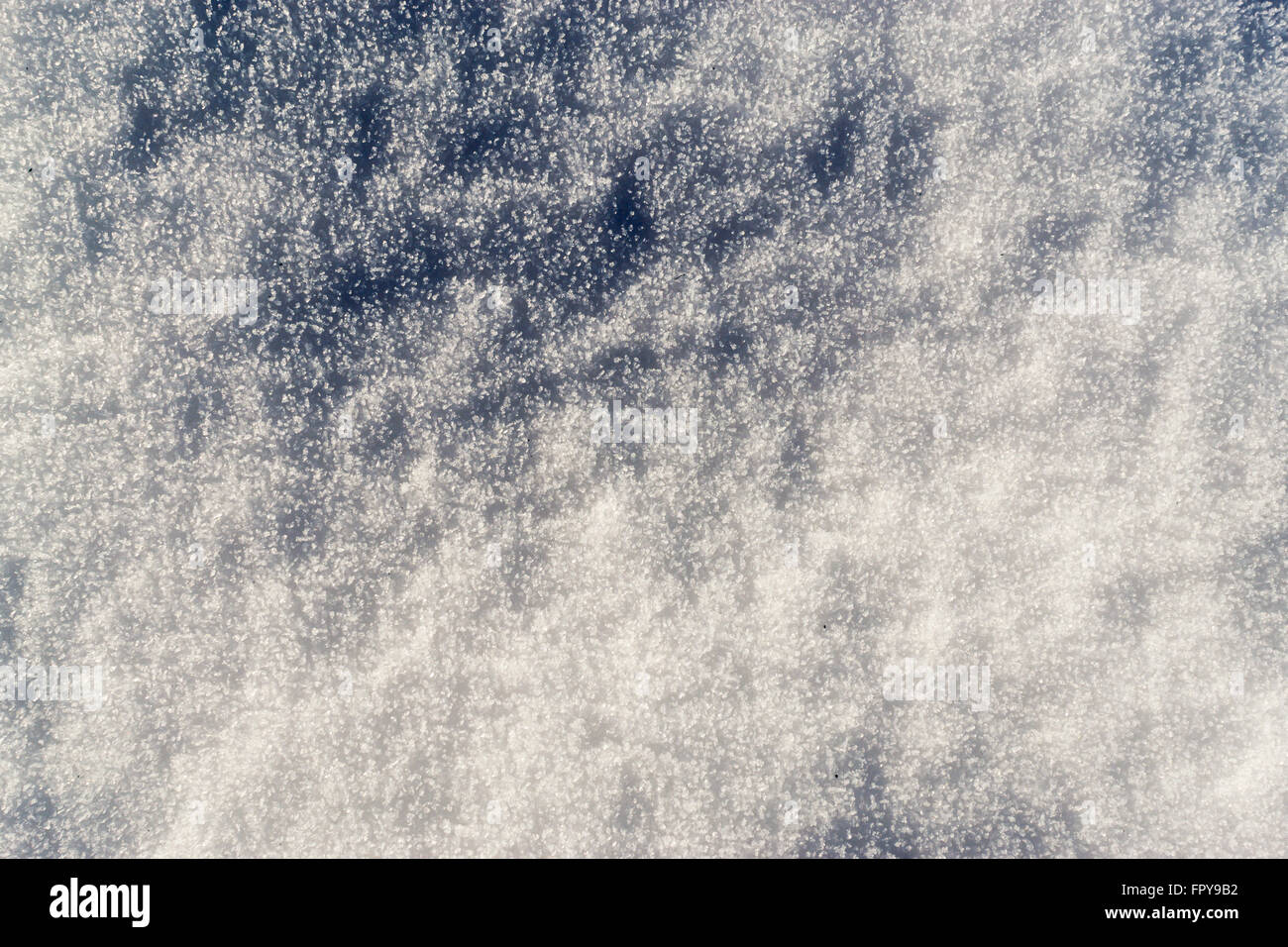 Natural snow background using daylight to reveal snowflakes and frost ...