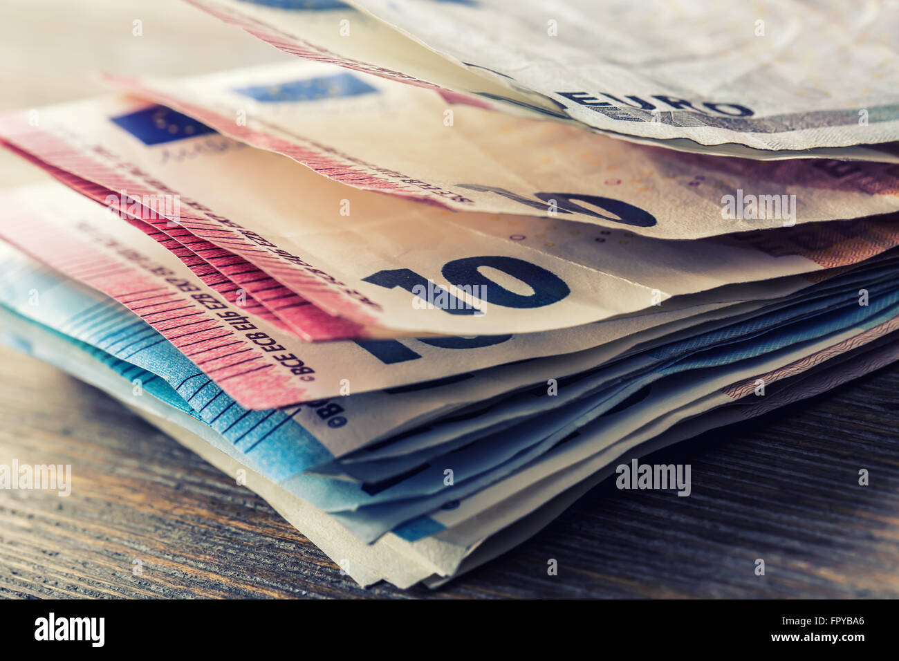 Several hundred euro banknotes stacked by value. Euro money concept ...