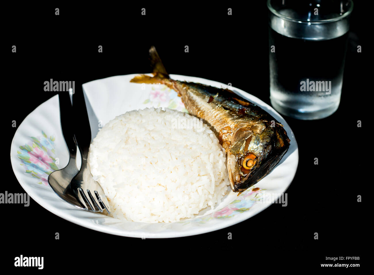 Food, Rice and fish cooked in a dish on a black cloth Stock Photo - Alamy