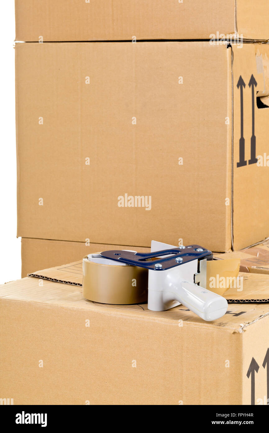 Tape roller on stack of moving carton boxes over white background Stock ...