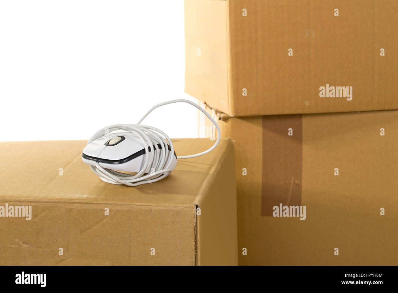 Computer mouse on moving boxes over white background - office moving or ...