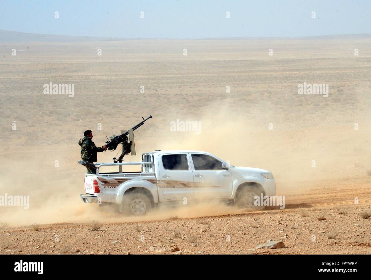Damascus, Syria. 19th Mar, 2016. A Syrian soldier fires his Dushka ...