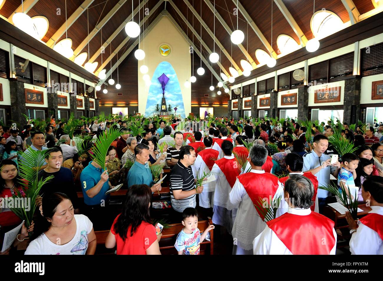 Indonesian Catholics devotees hold palm as they pray during Palm Sunday ... Indonesian Catholics devotees hold palm as they pray during Palm Sunday ...
