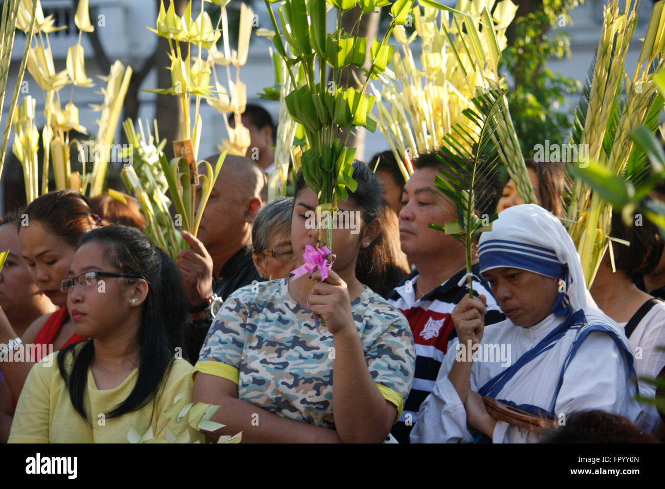 Filipinos hold palm fronds during a ceremonial blessing led by Manila ...
