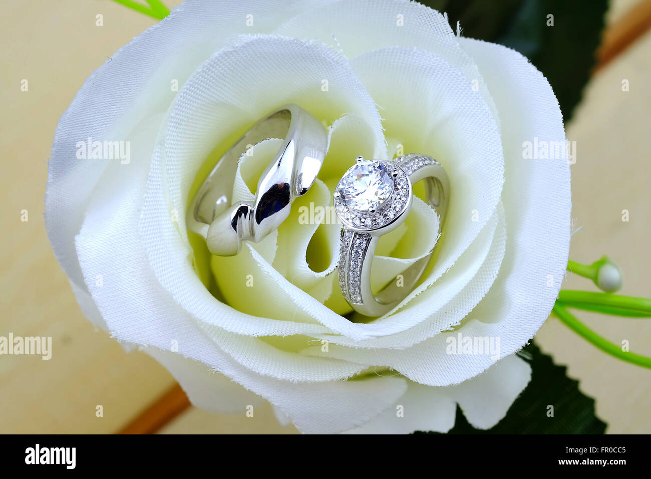 wedding rings with rose flowers Stock Photo - Alamy