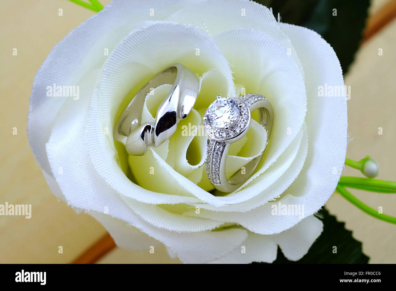 wedding rings with rose flowers Stock Photo - Alamy