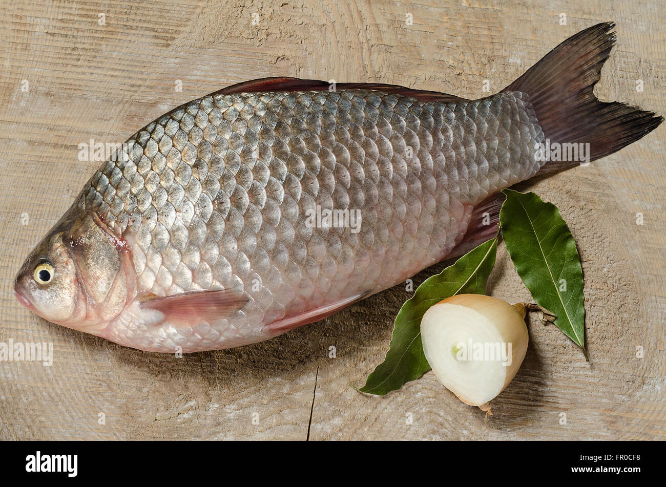 Raw fish on a rough wooden background Stock Photo - Alamy