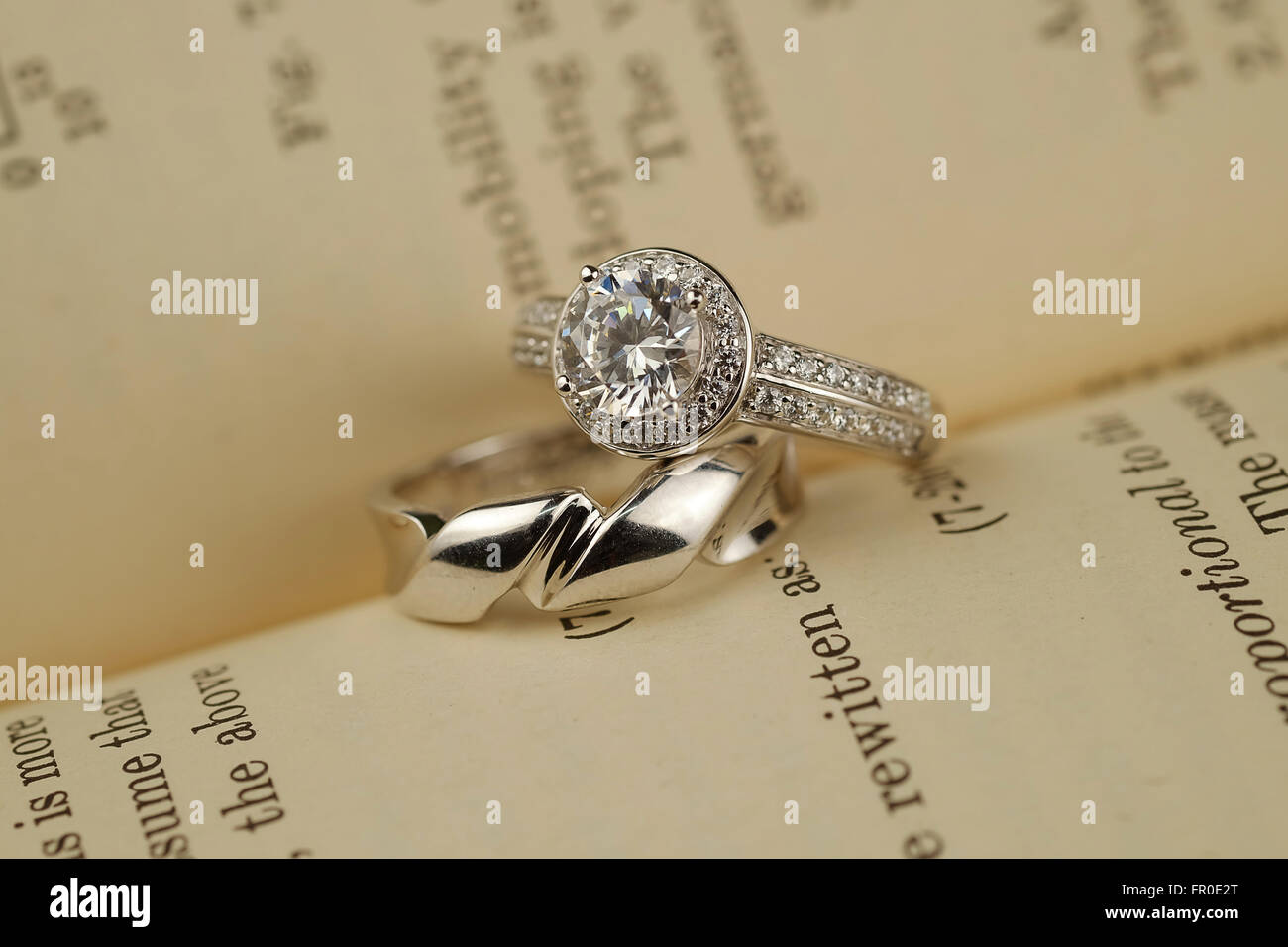 wedding rings on book Stock Photo - Alamy