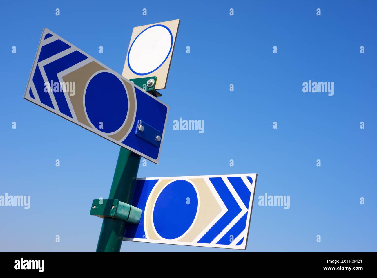 Directional signals in a pole with blue sky Stock Photo - Alamy