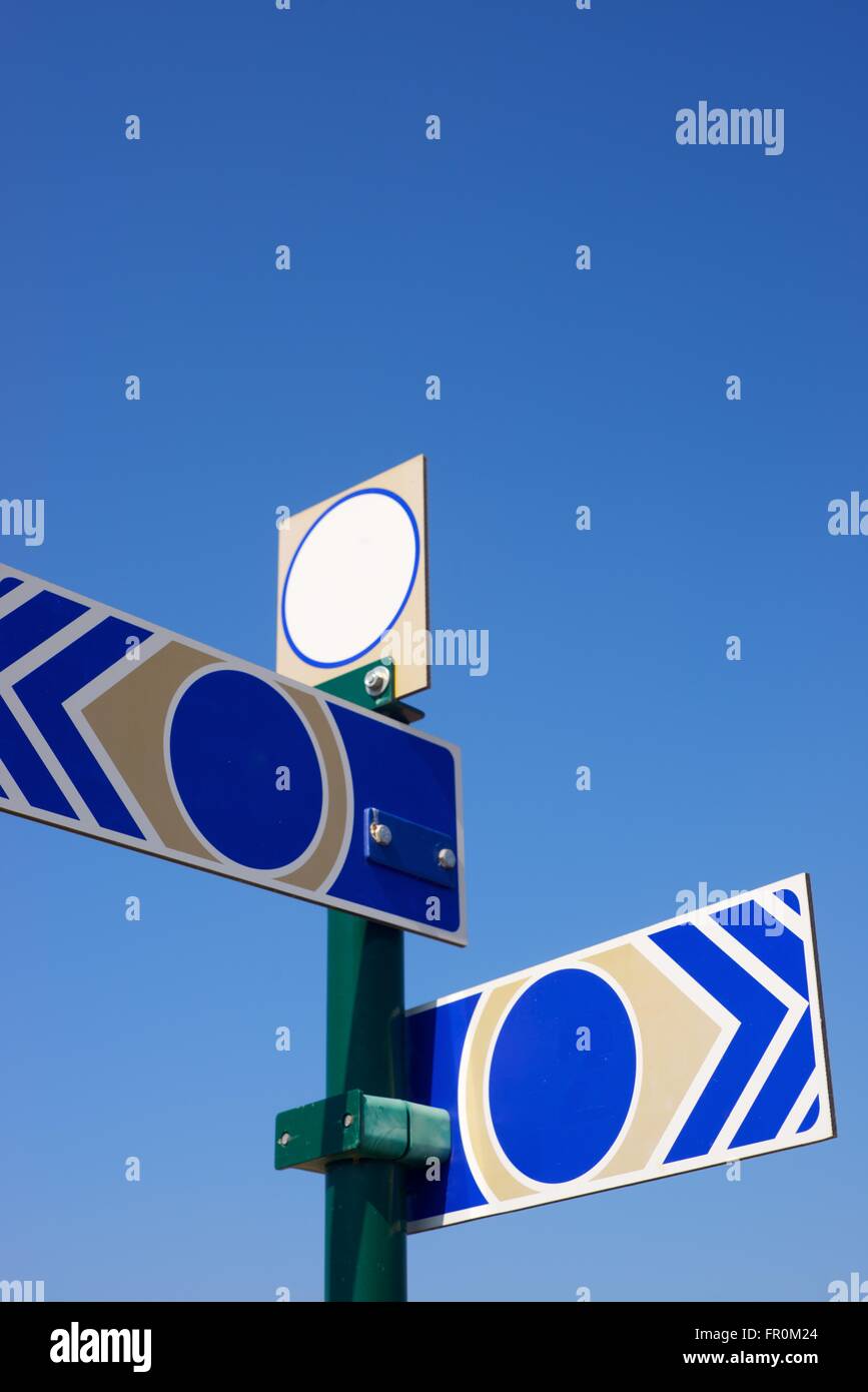 Directional signals in a pole with blue sky Stock Photo - Alamy