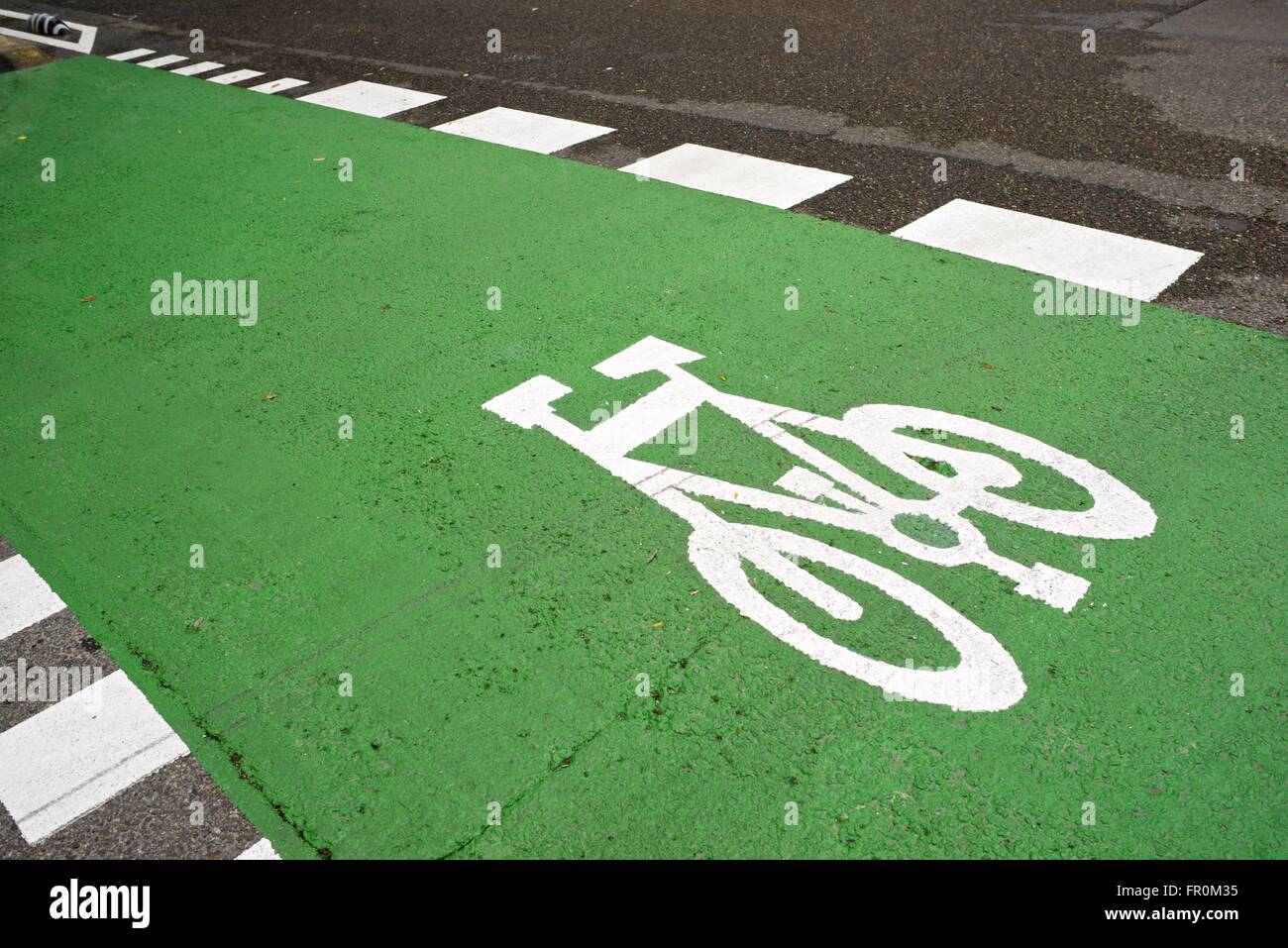 Bike lane sign painted on a street Stock Photo - Alamy