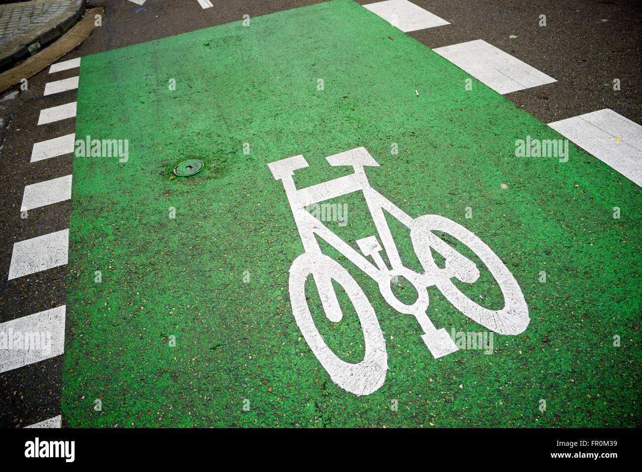 Bike lane sign painted on a street Stock Photo - Alamy