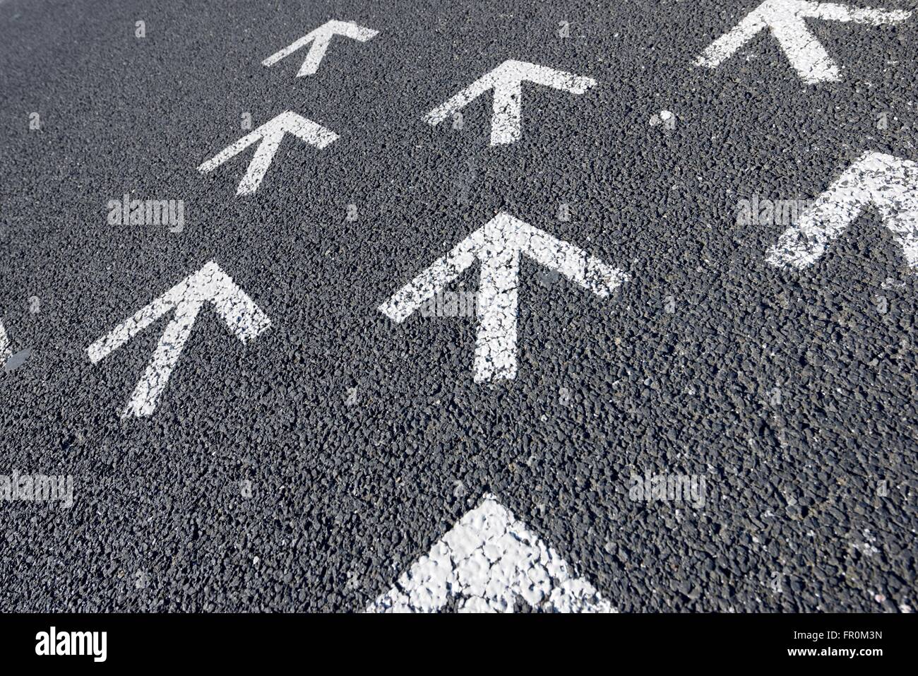 Directional arrows painted on a cement floor Stock Photo - Alamy