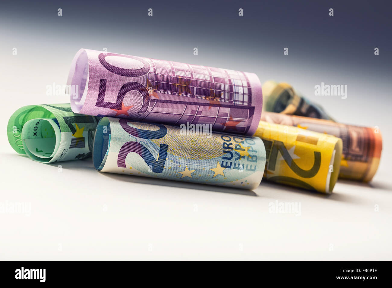 Several hundred euro banknotes stacked by value.Rolls Euro banknotes ...