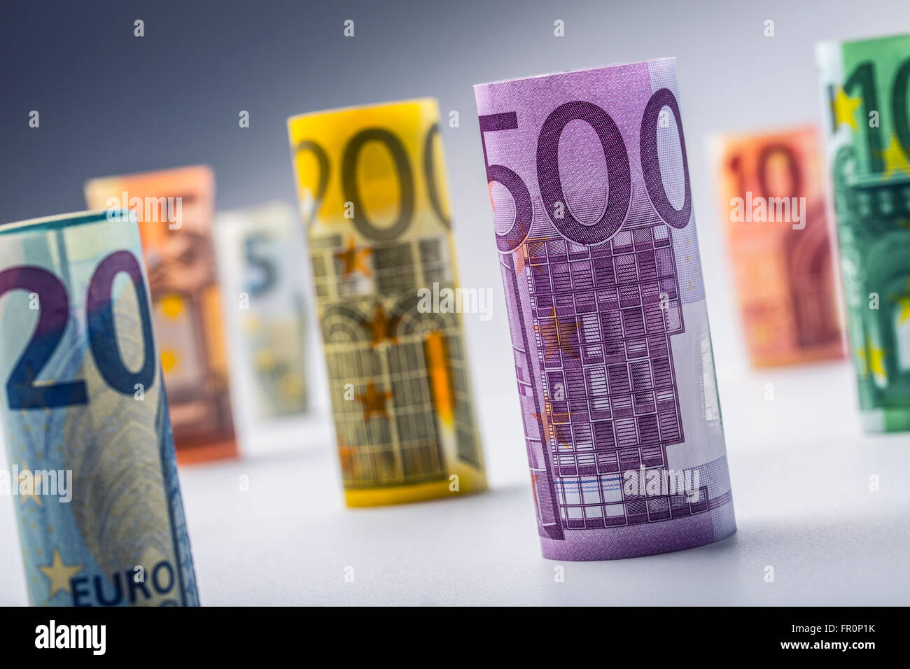 Several hundred euro banknotes stacked by value.Rolls Euro banknotes ...