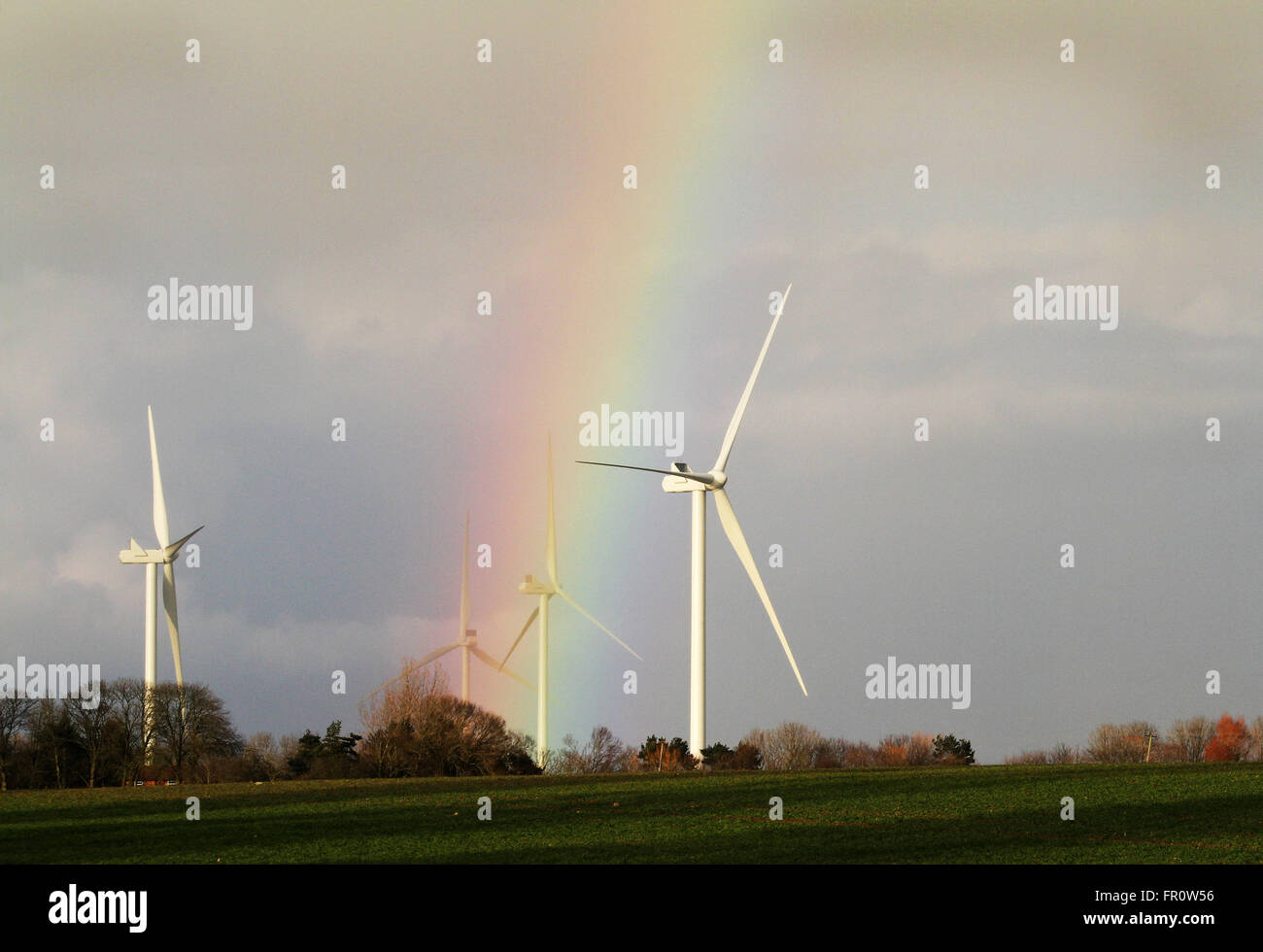 Wind turbines with rainbow Stock Photo - Alamy