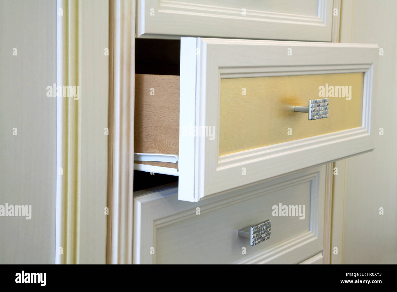 Modern white cabinet with drawers and handles Stock Photo - Alamy