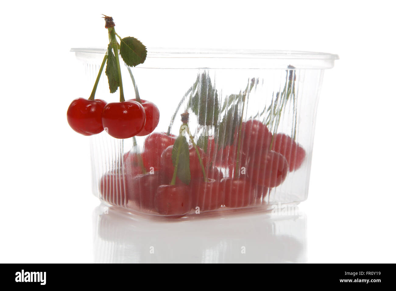 Fresh cherry in transparent packing on a white background Stock Photo ...