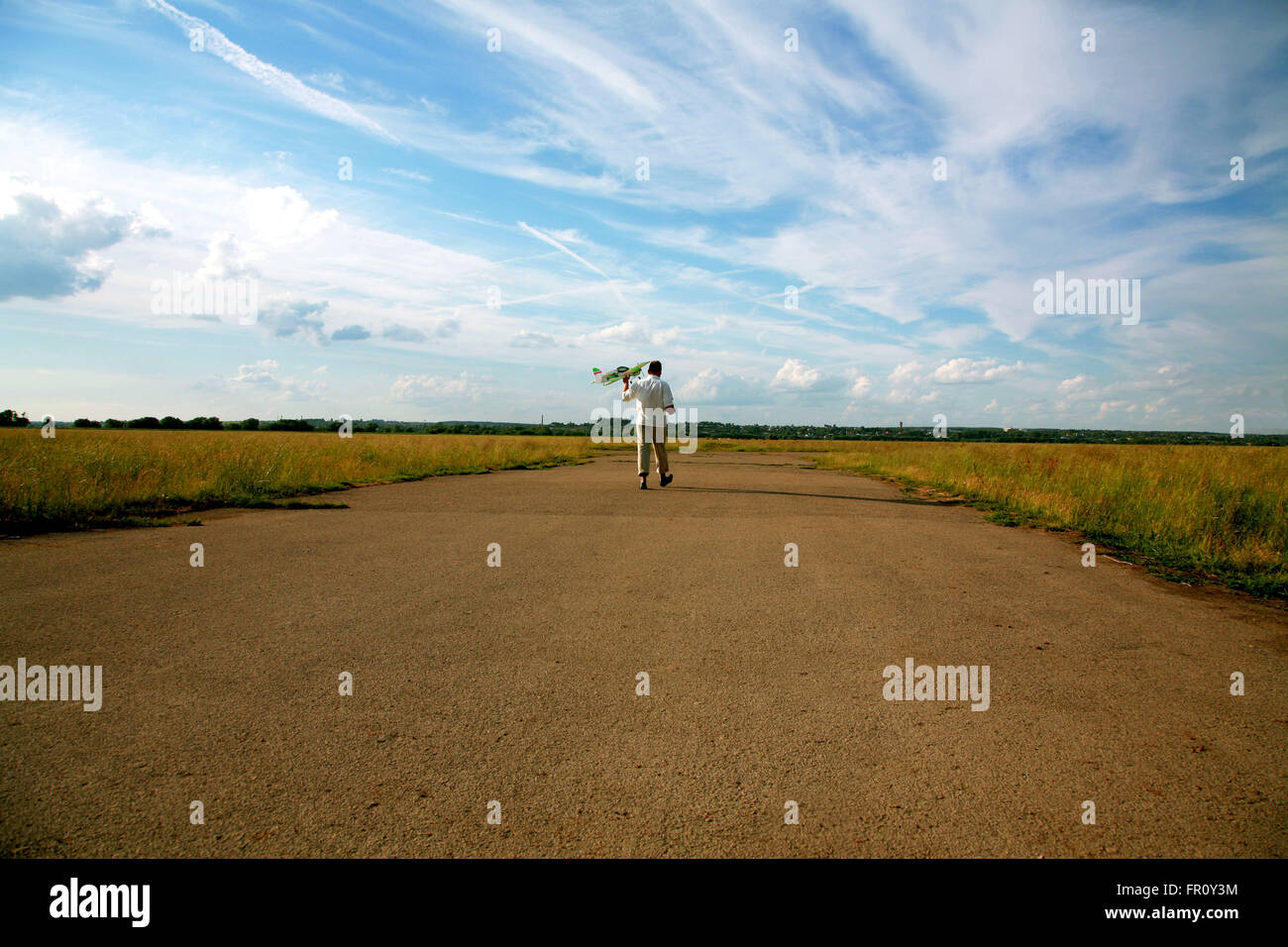 The man on road with model of the plane Stock Photo - Alamy