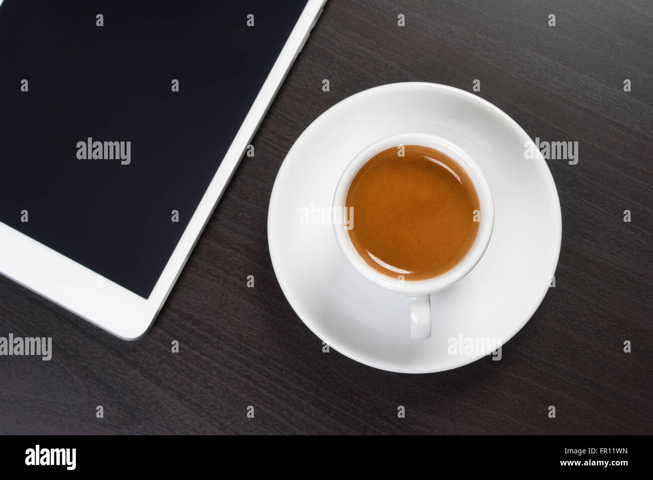 Touch tablet and coffee on office table Stock Photo - Alamy