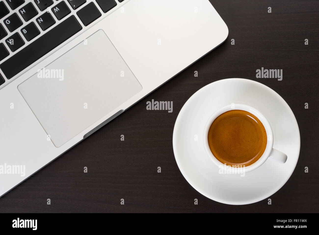 Laptop and coffee on office table Stock Photo - Alamy