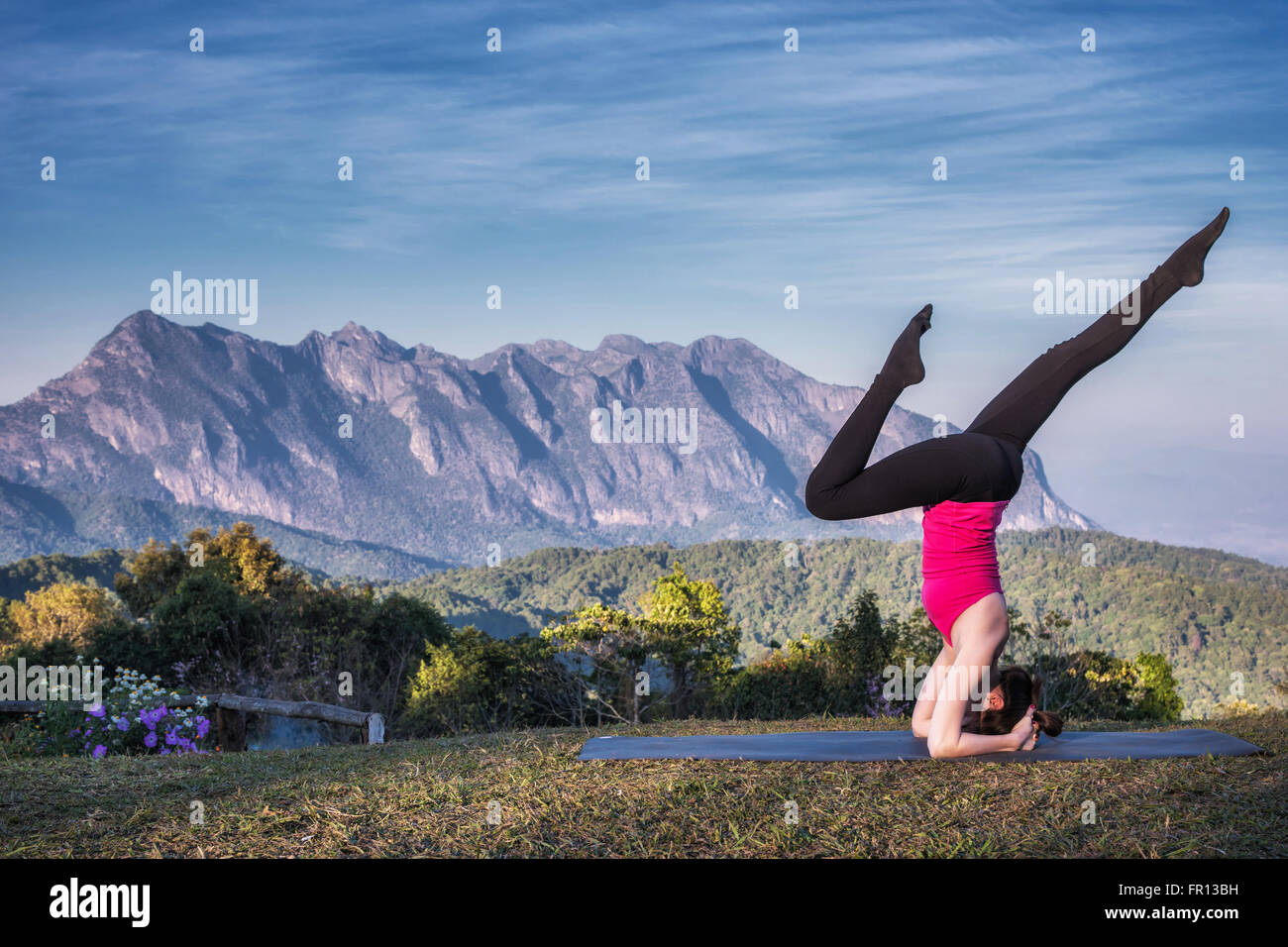 Female doing yoga outdoor in beautiful mountains landscape. Exercise ...