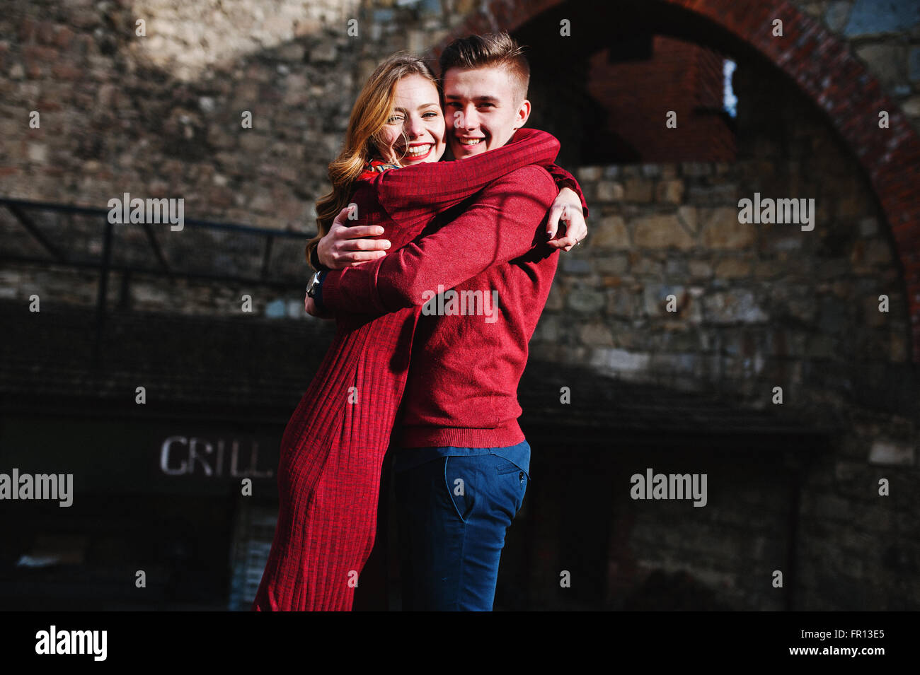 Young beautiful stylish fashion couple in a red dress in love story at ...