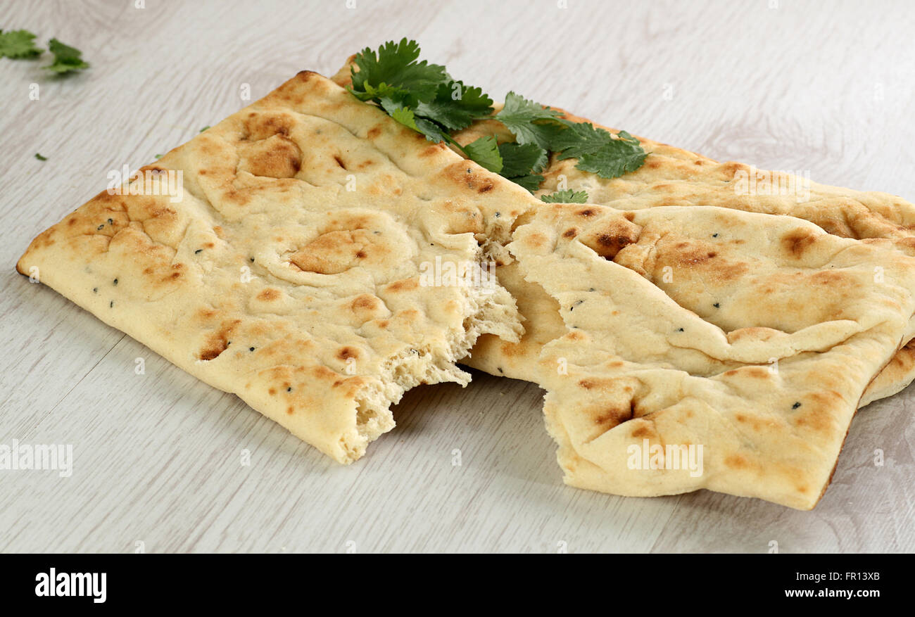 homemade oblong shaped naan bread with coriander Stock Photo - Alamy