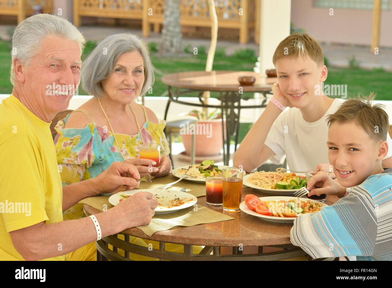 Grandparents with grandchildren at breakfast Stock Photo - Alamy